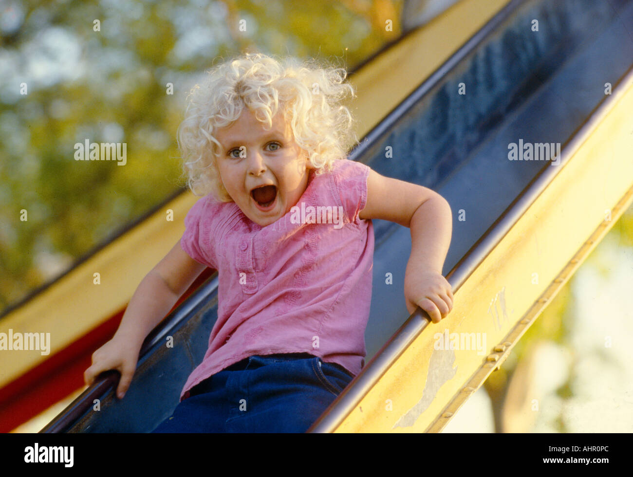 Child going down playground slide hi-res stock photography and images ...