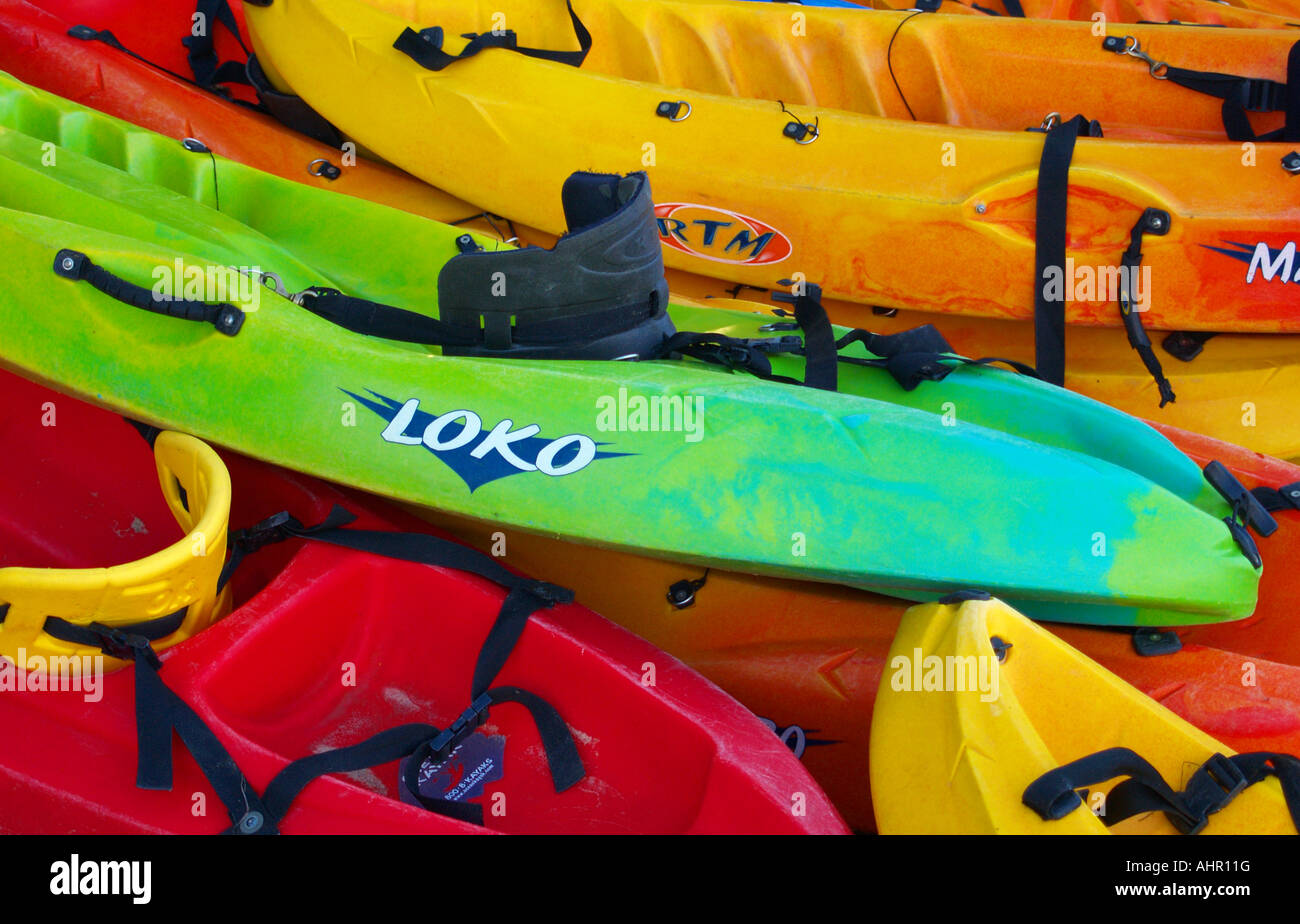 A pile of brightly coloured sea kayaks Stock Photo - Alamy