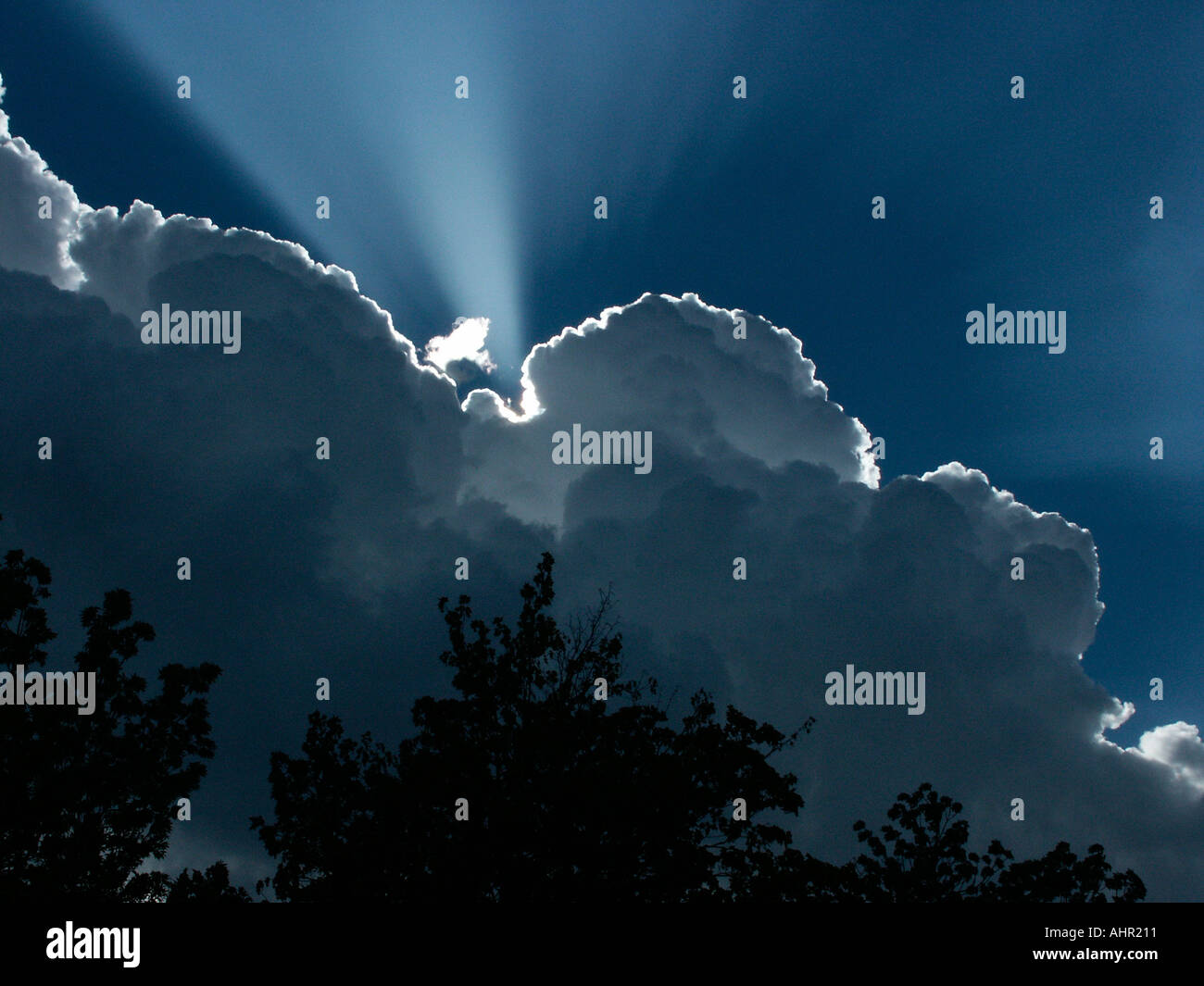 Sunburst through storm clouds Stock Photo - Alamy