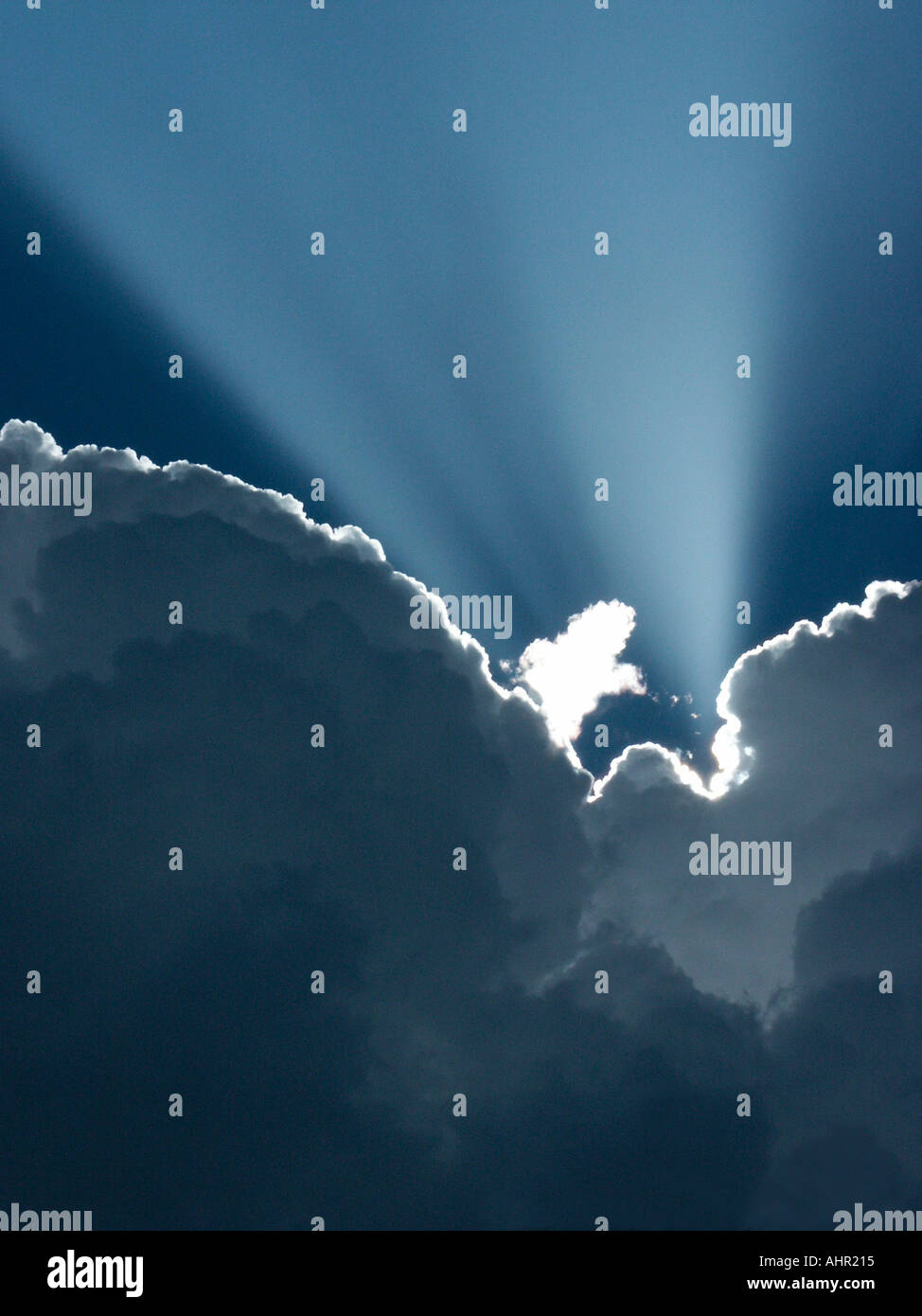 Sunburst through storm clouds Stock Photo - Alamy