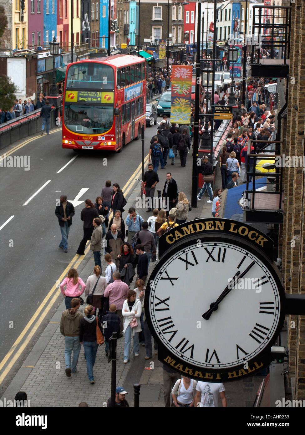 Red doubledecker London bus on Camden High Street sidewalks crowded ...