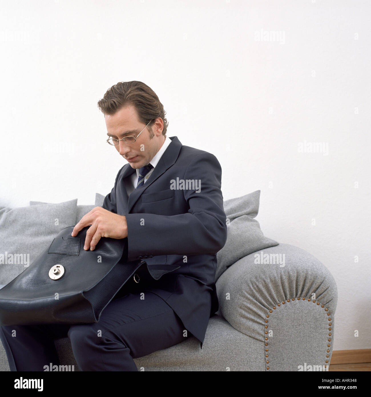 Man searching in his briefcase Stock Photo - Alamy
