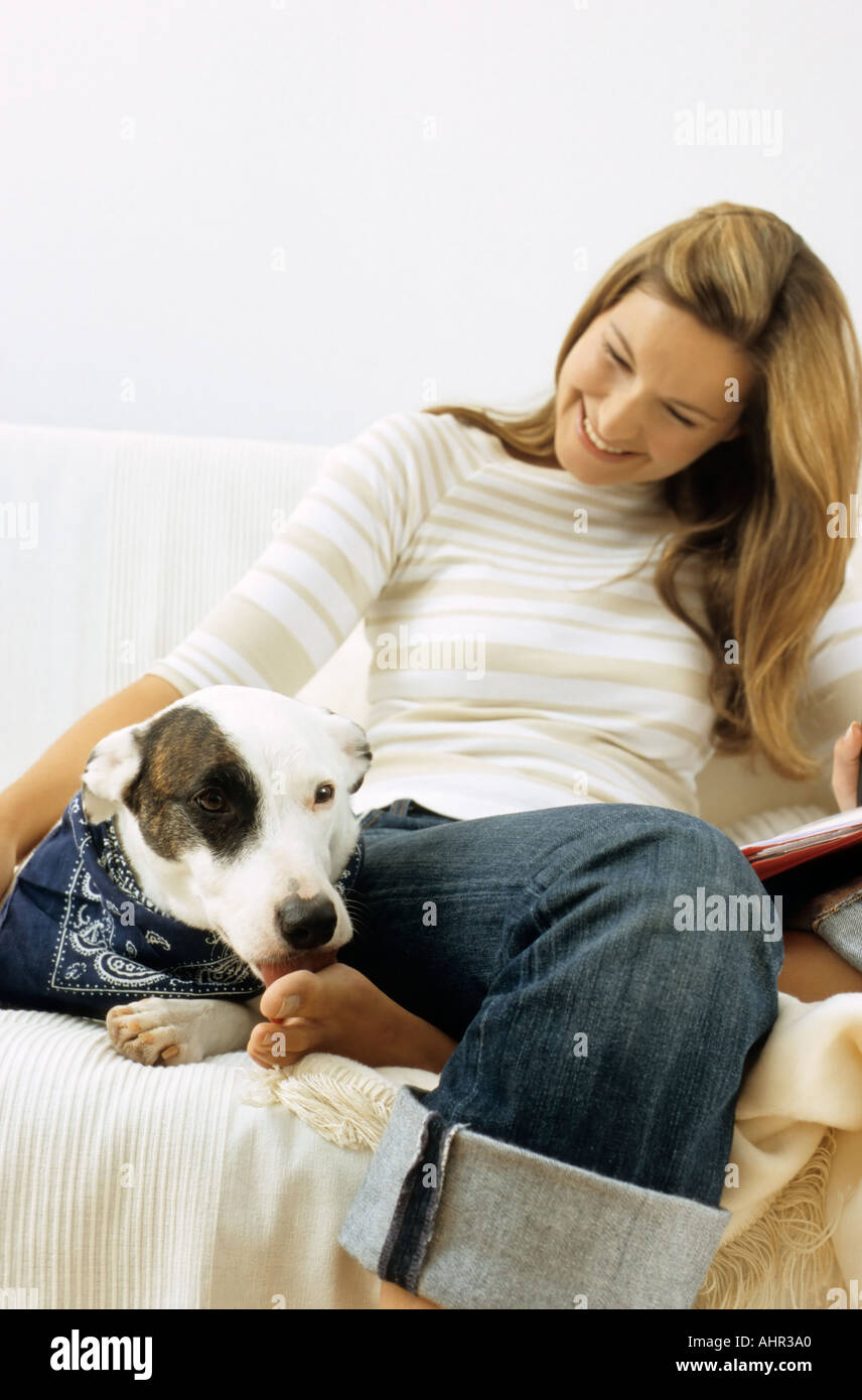 Dog and lady owner on sofa Stock Photo - Alamy