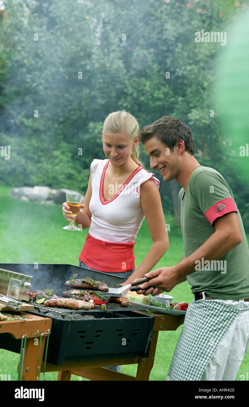 Friends cooking on barbecue Stock Photo - Alamy