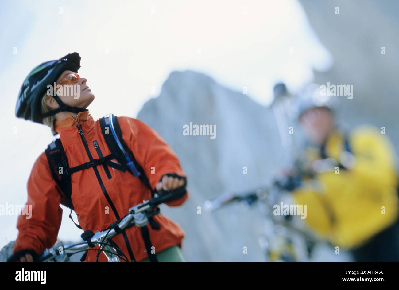 A female mountain biker looking up Stock Photo - Alamy