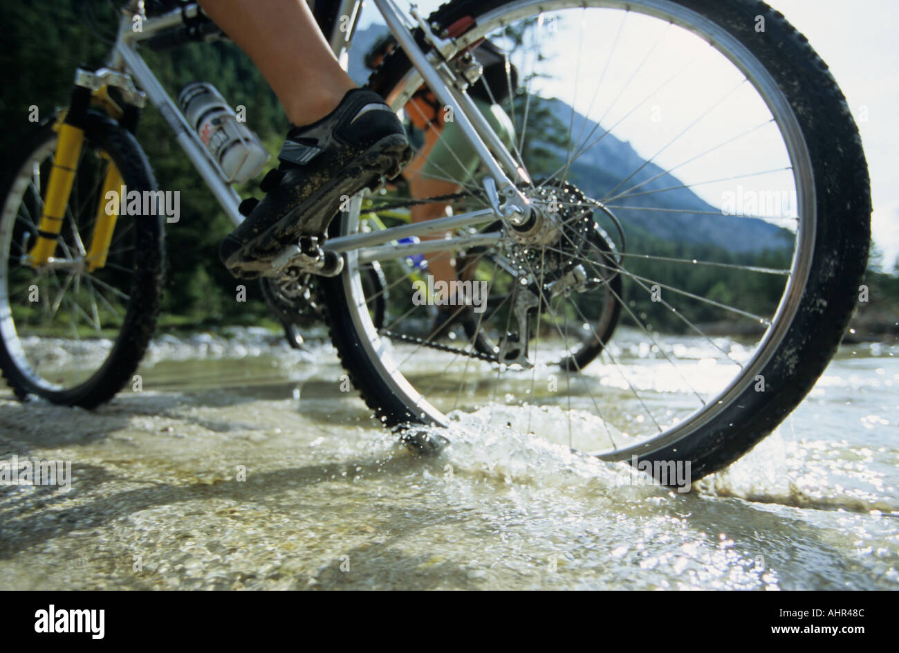 People cycling across a stream Stock Photo - Alamy