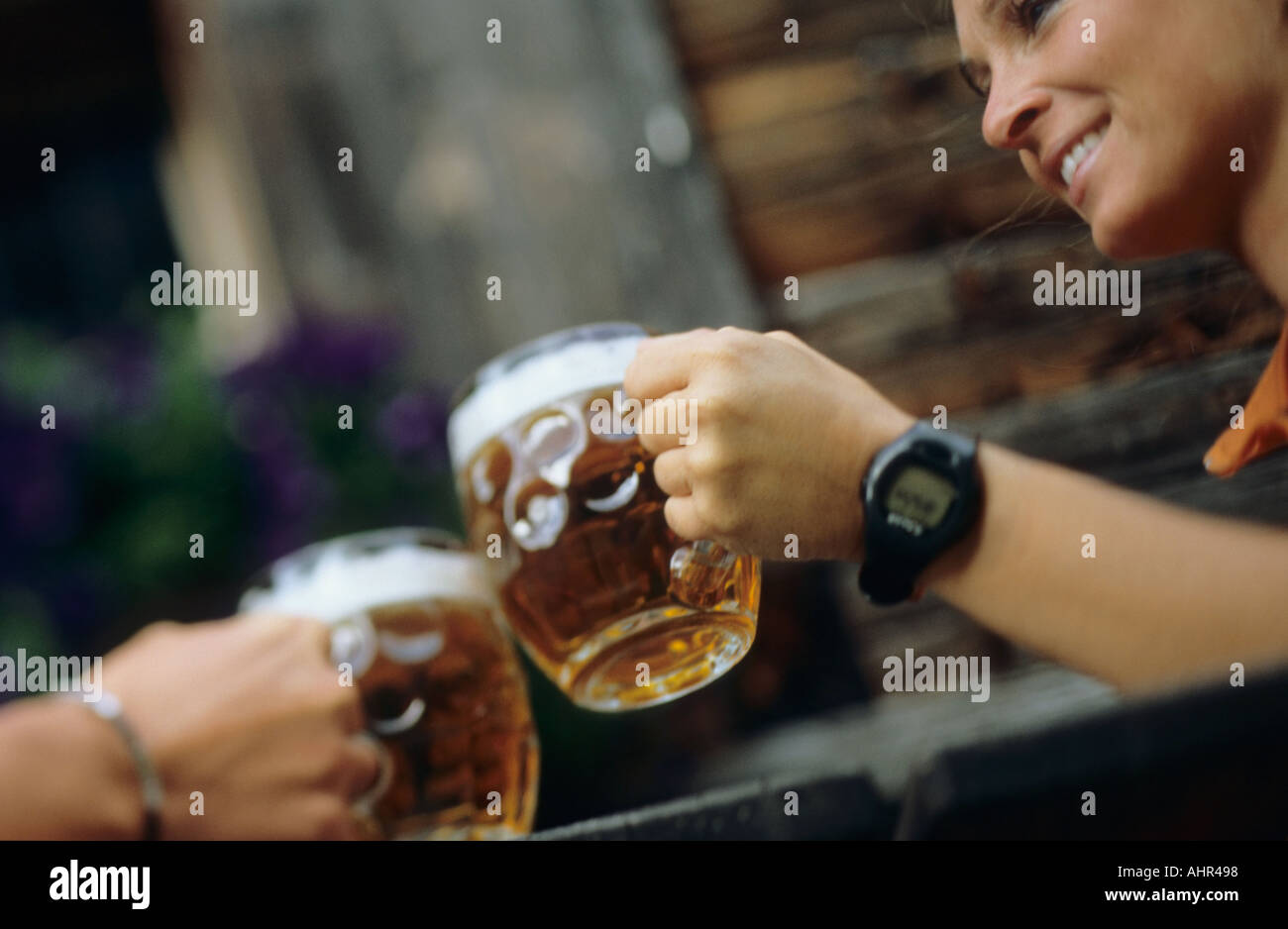 Two people toasting with beer Stock Photo - Alamy