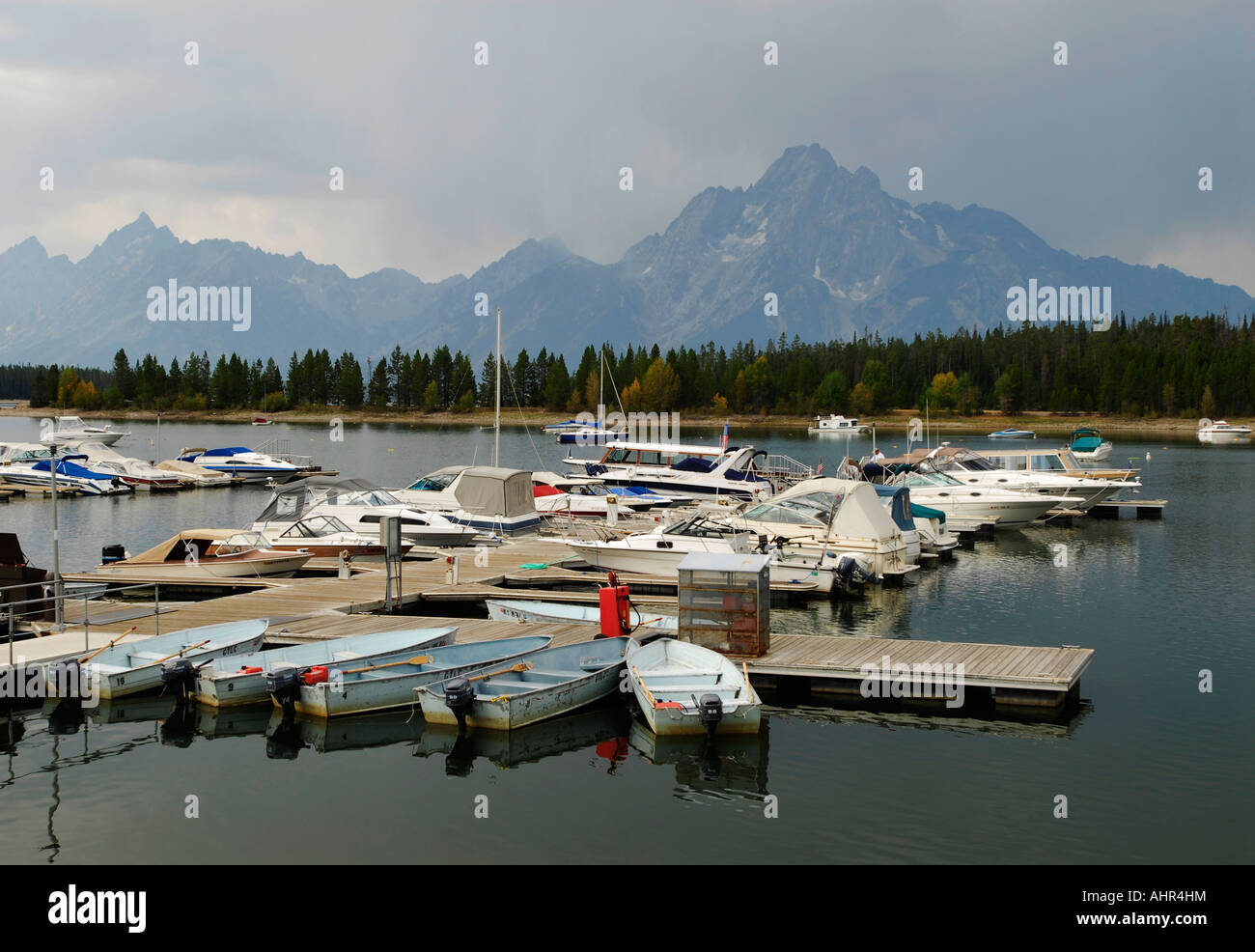 In the mist of dawn, boats line a dock at Colter Bay on Jackson Lake in ...