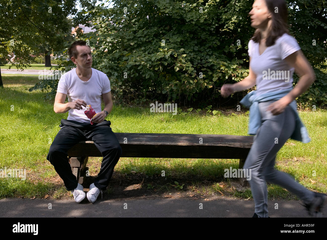 Two people sat on a park bench hi-res stock photography and images - Alamy