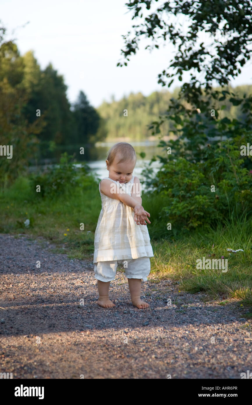 Toddler walking on a gravel road Stock Photo - Alamy