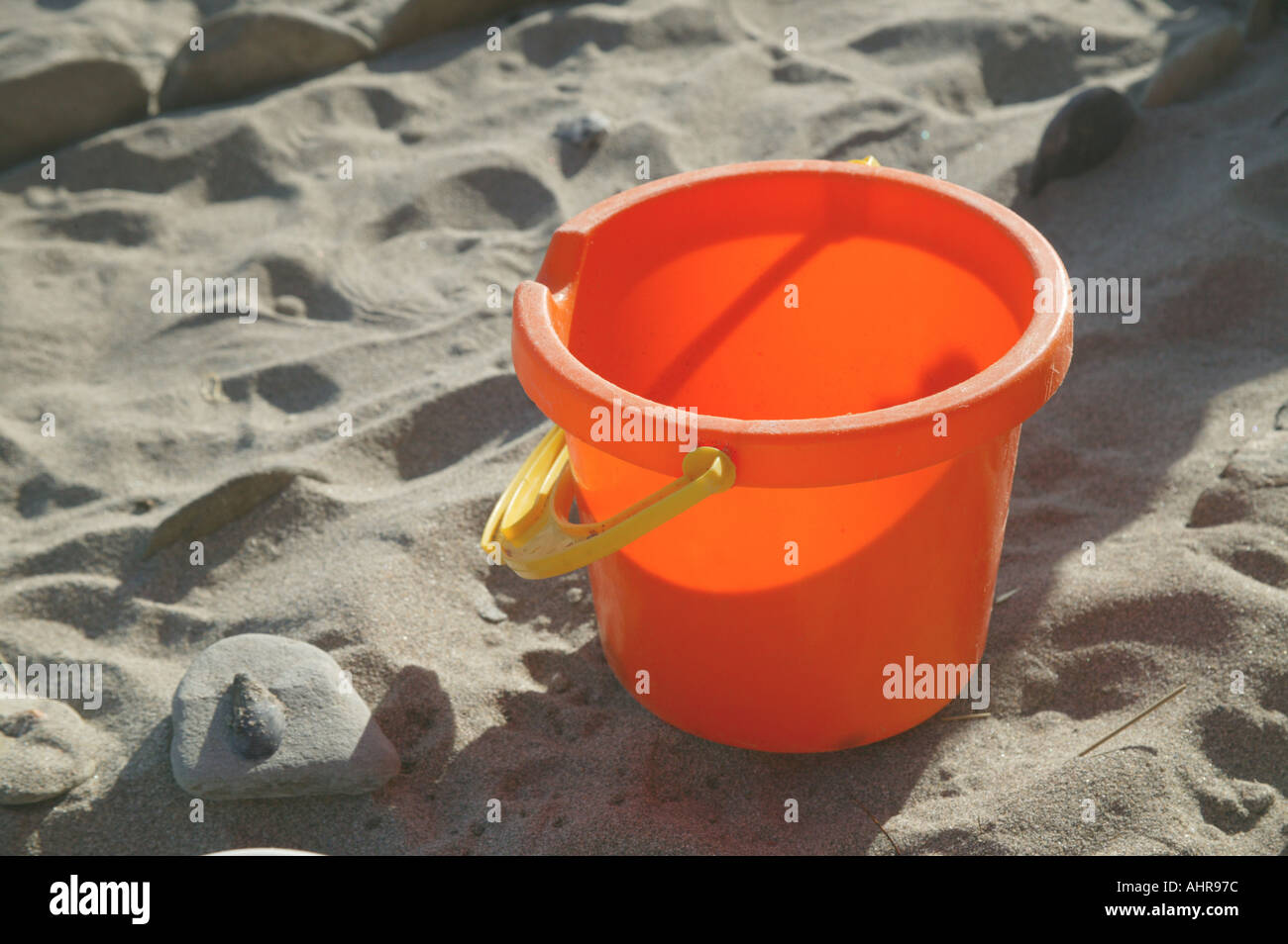Bucket on the beach Stock Photo - Alamy