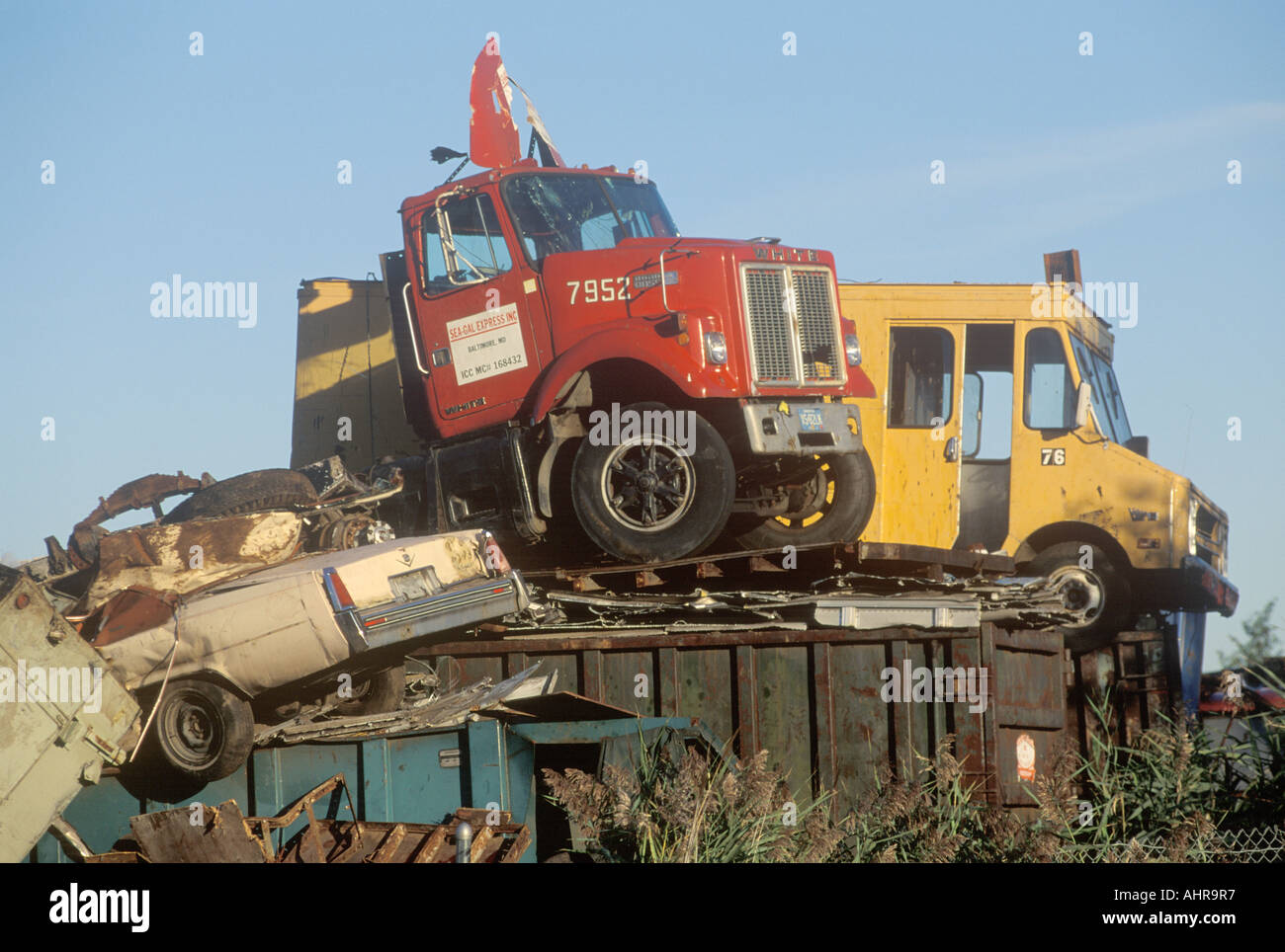 Old trucks and cars sitting on top of a scrap heap in a junk yard in ...