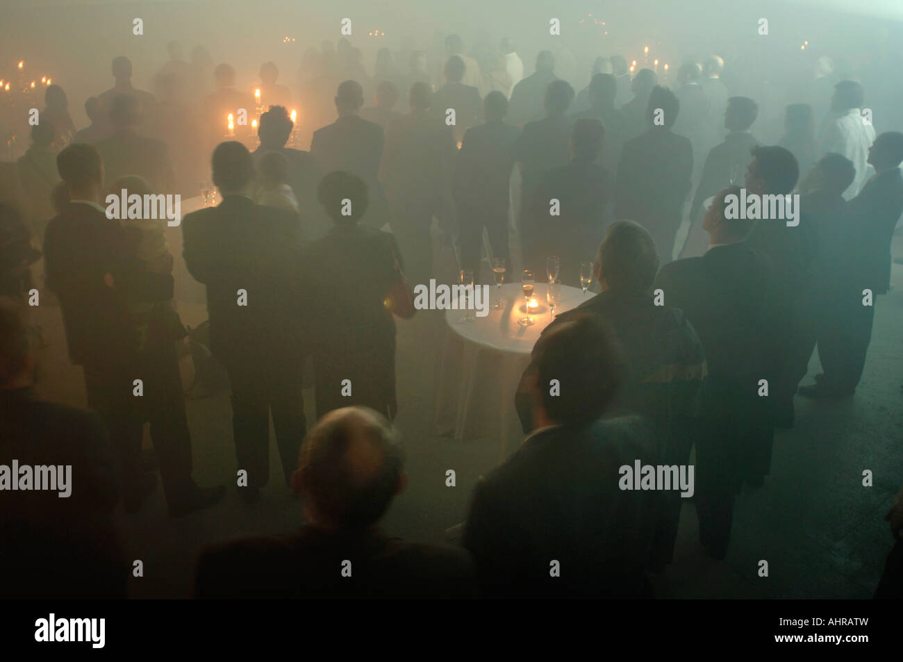 Crowds of dim figures in spectacular interior lighting with candles ...