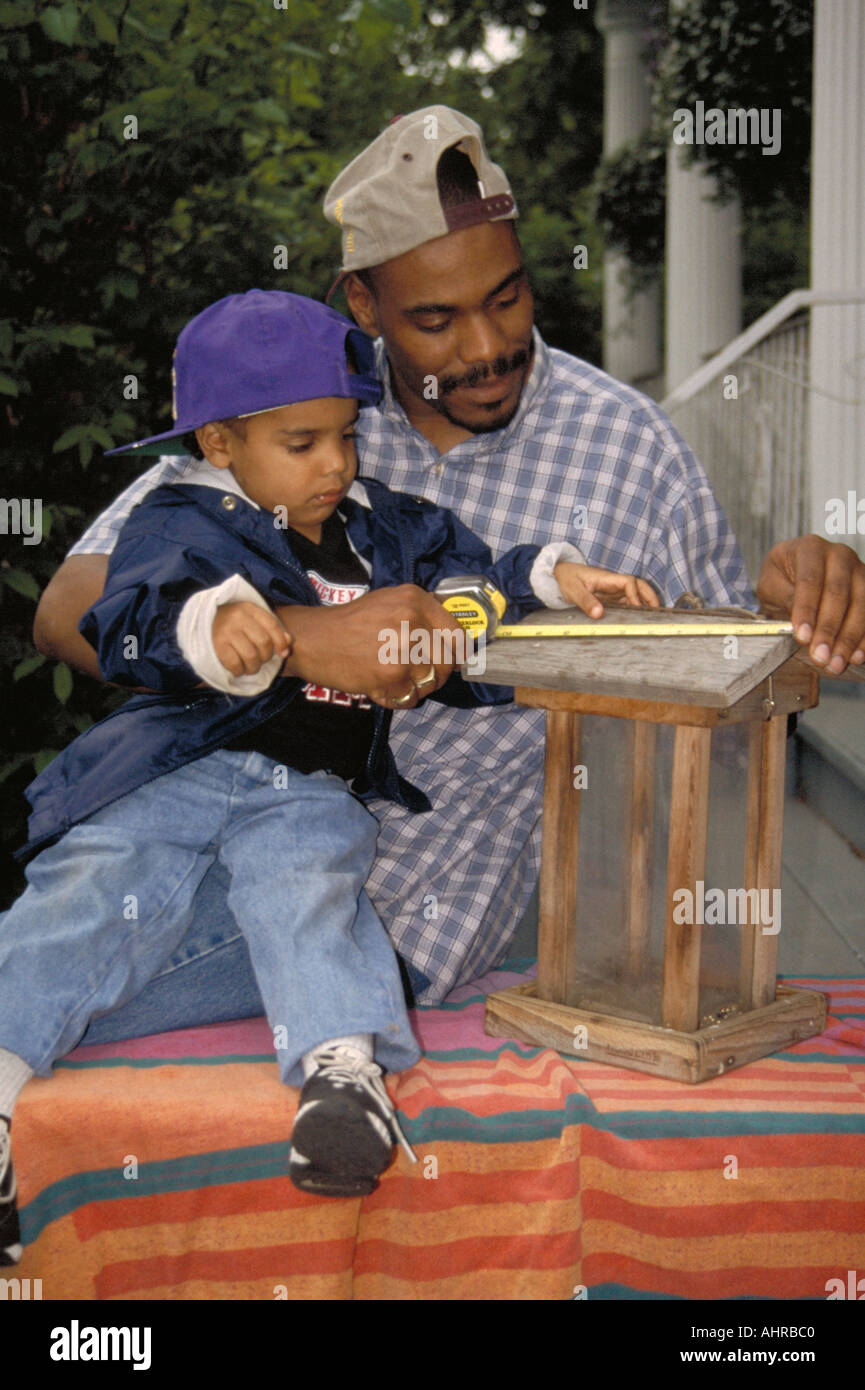 Father and son working on a bird feeder St Paul Minnesota Stock Photo ...