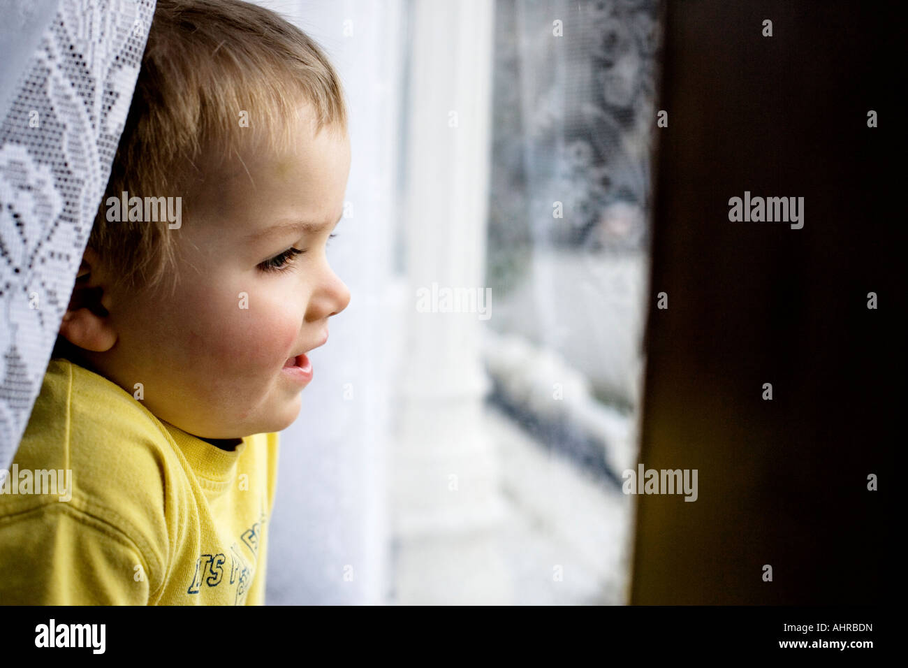 boy looking out of window Stock Photo - Alamy