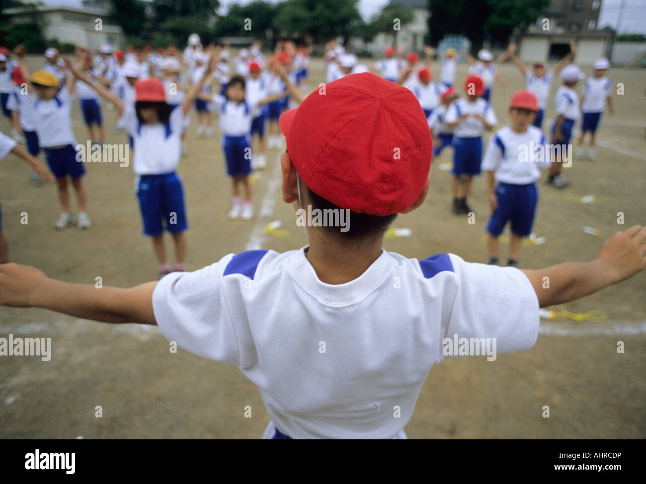 An Elementary School Student Leads His Class In Warm Ups For A PE Class an-elementary-school-student-leads-his-class-in-warm-ups-for-a-pe-class