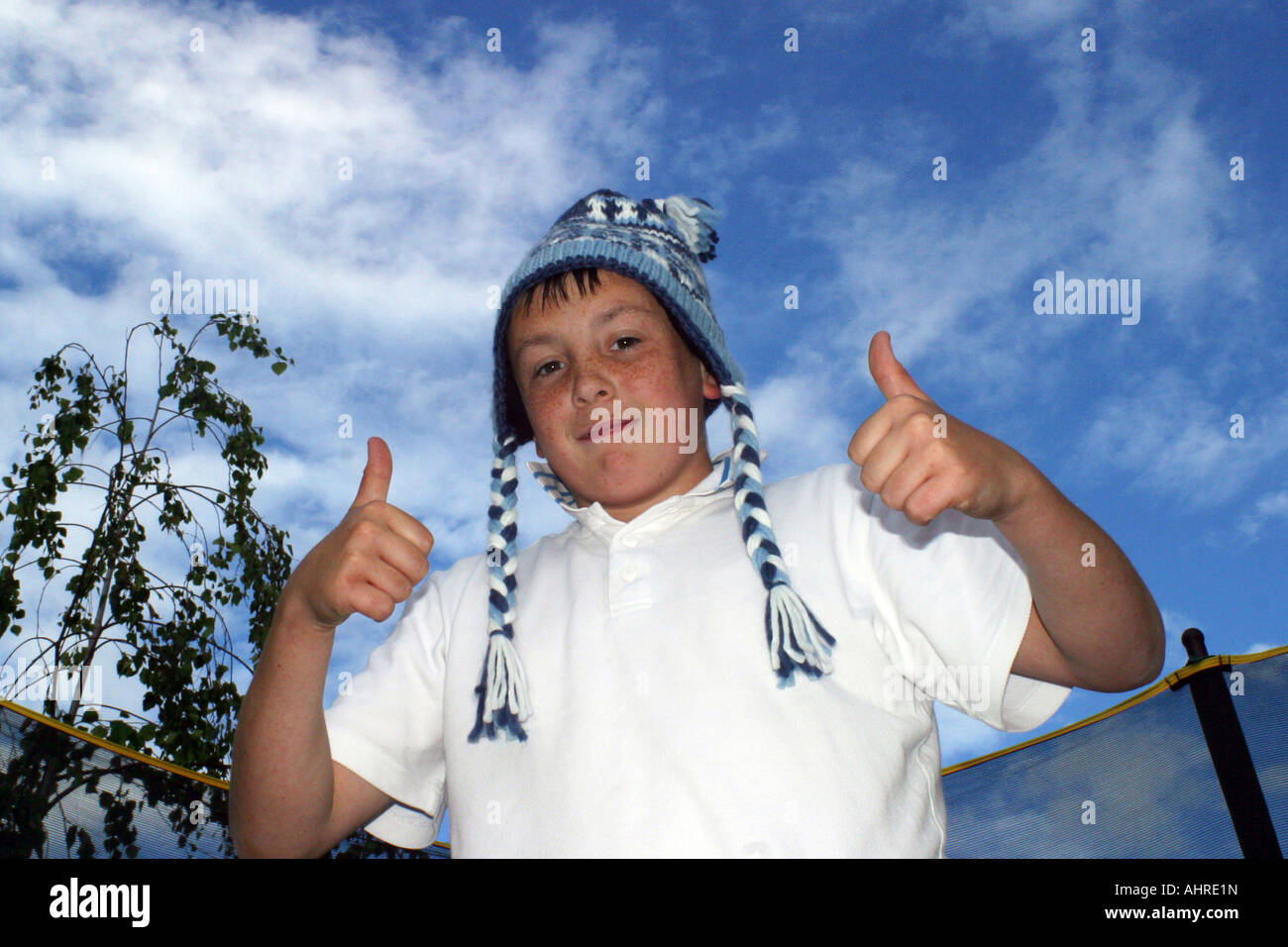 Young adult happy white boy in his back garden with his thumbs up Stock ...