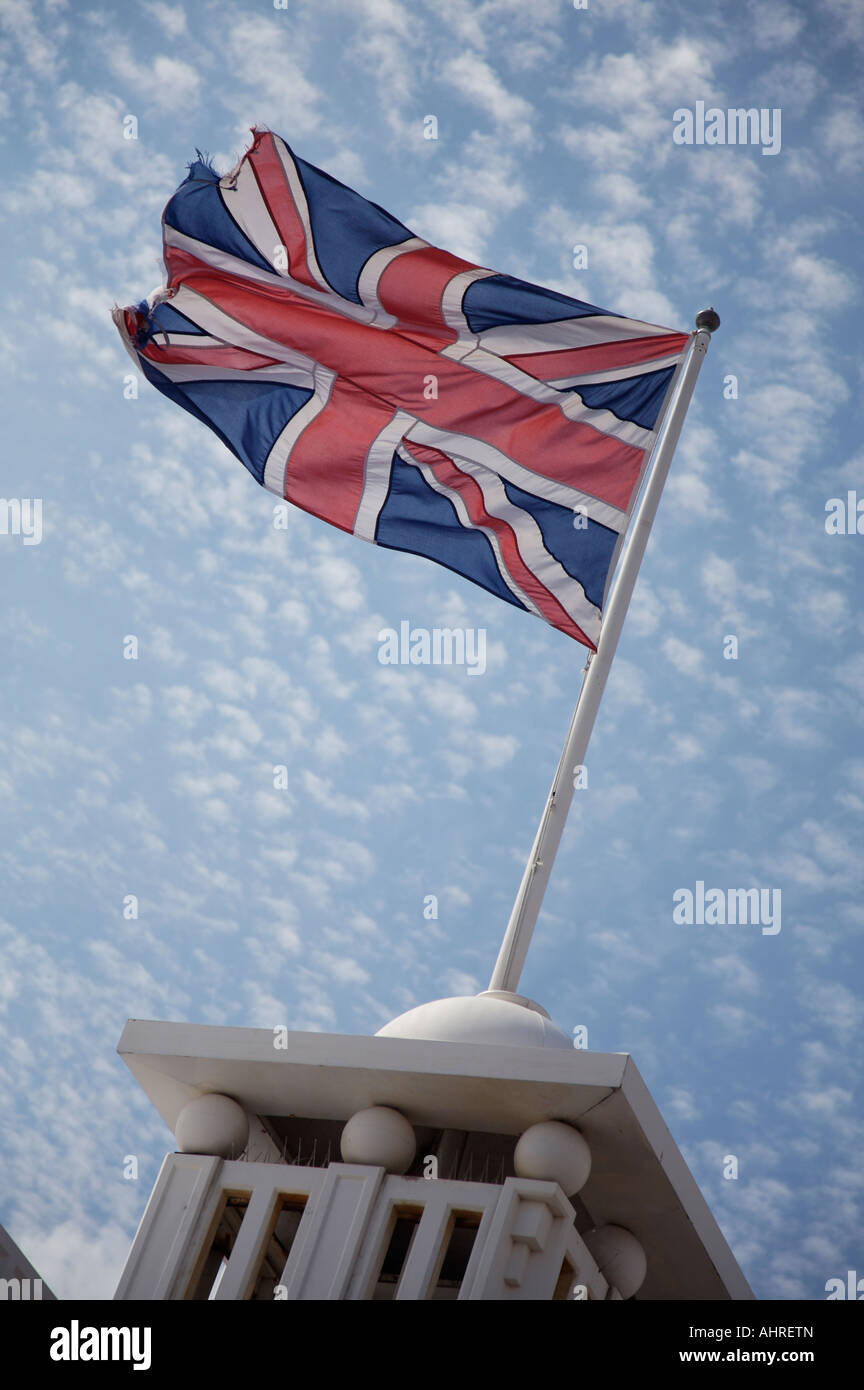 union jack flag blowing in the sea breeze against a blue summer sky ...