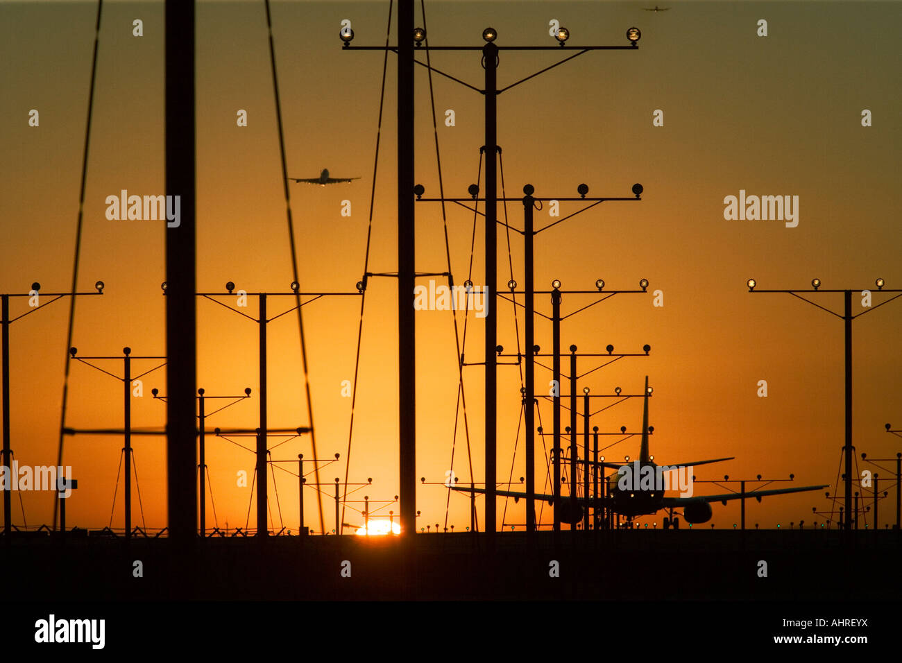 Airplane taking off into the sunset on a runway at LAX Stock Photo - Alamy