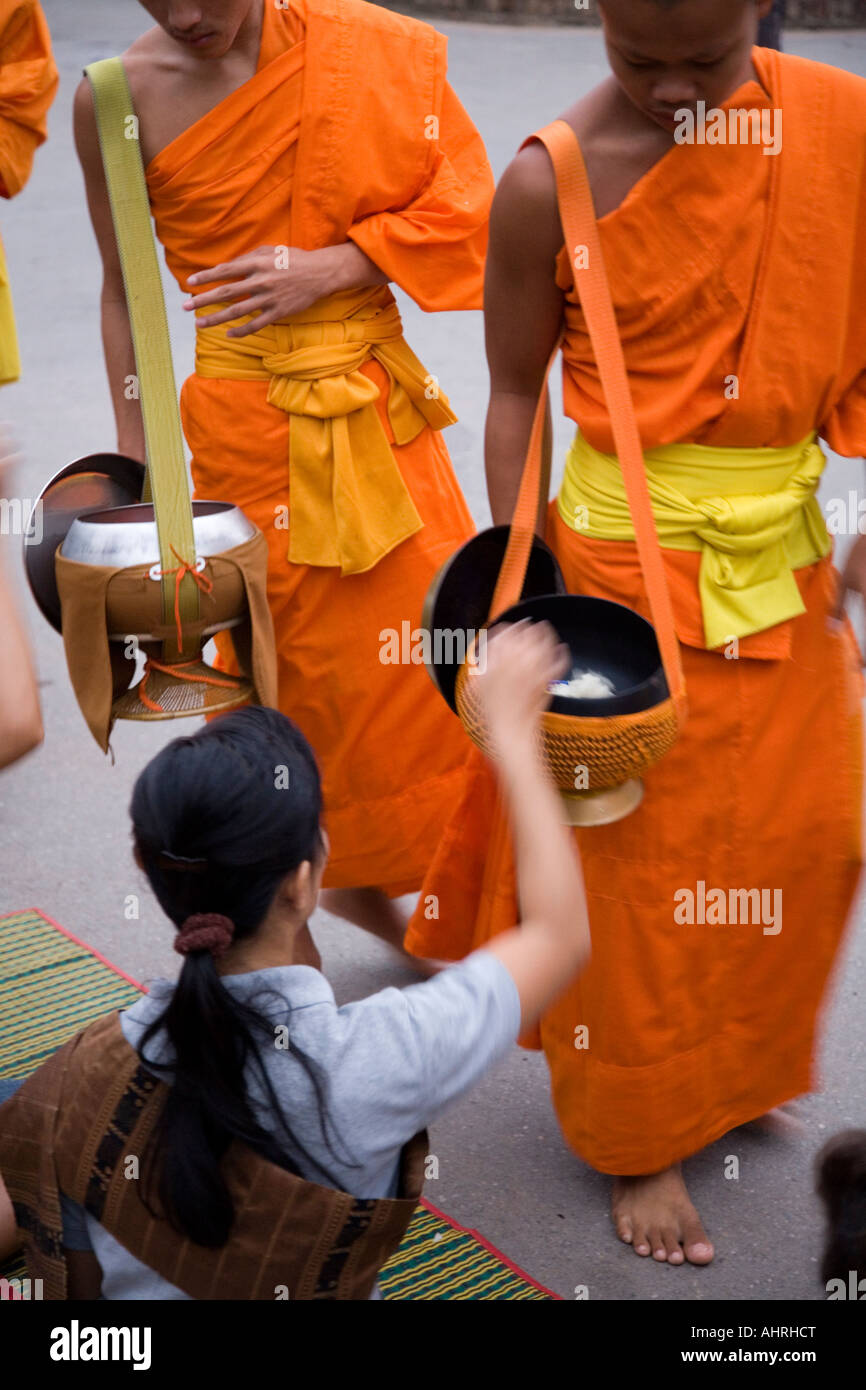 Local women give rice Alms to monks in Luang Prabang Laos Stock Photo ...