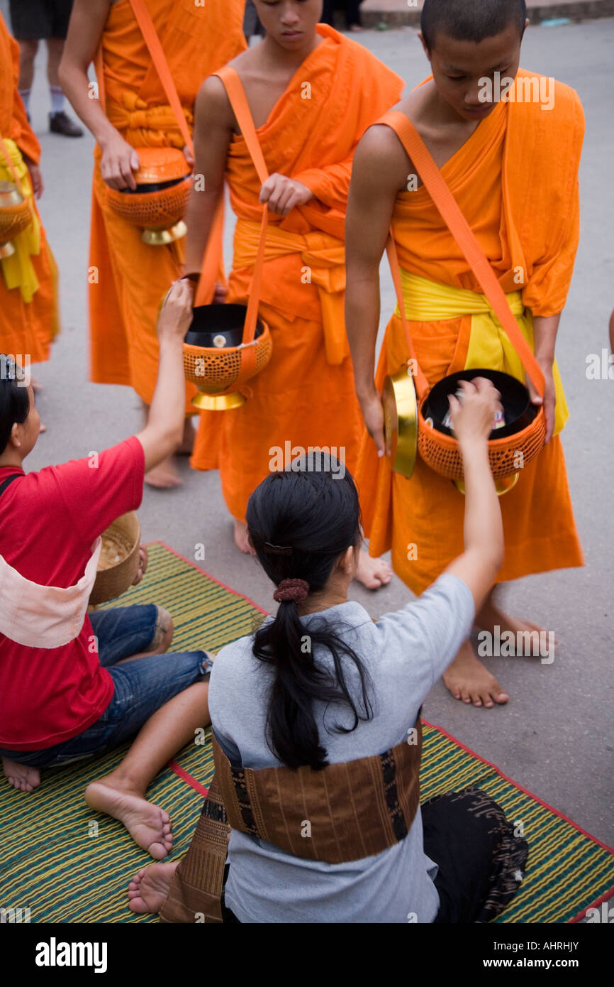 Local women give sticky rice as Alms to monks in Luang Prabang Laos ...