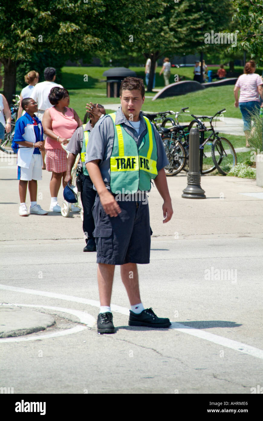 Traffic police direct pedestrian and automobile traffic in busy ...