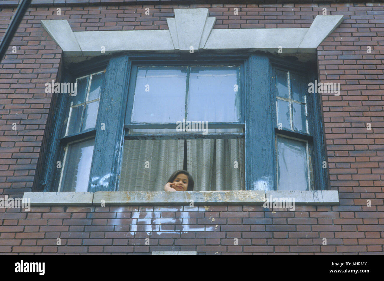 Child in window of residential project building South Bronx New York ...