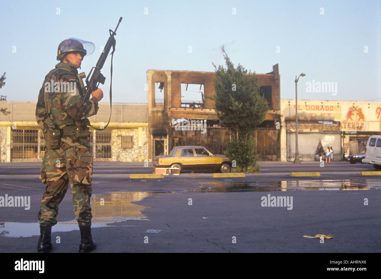 National Guardsman patrolling in front of burned business after 1992 ...