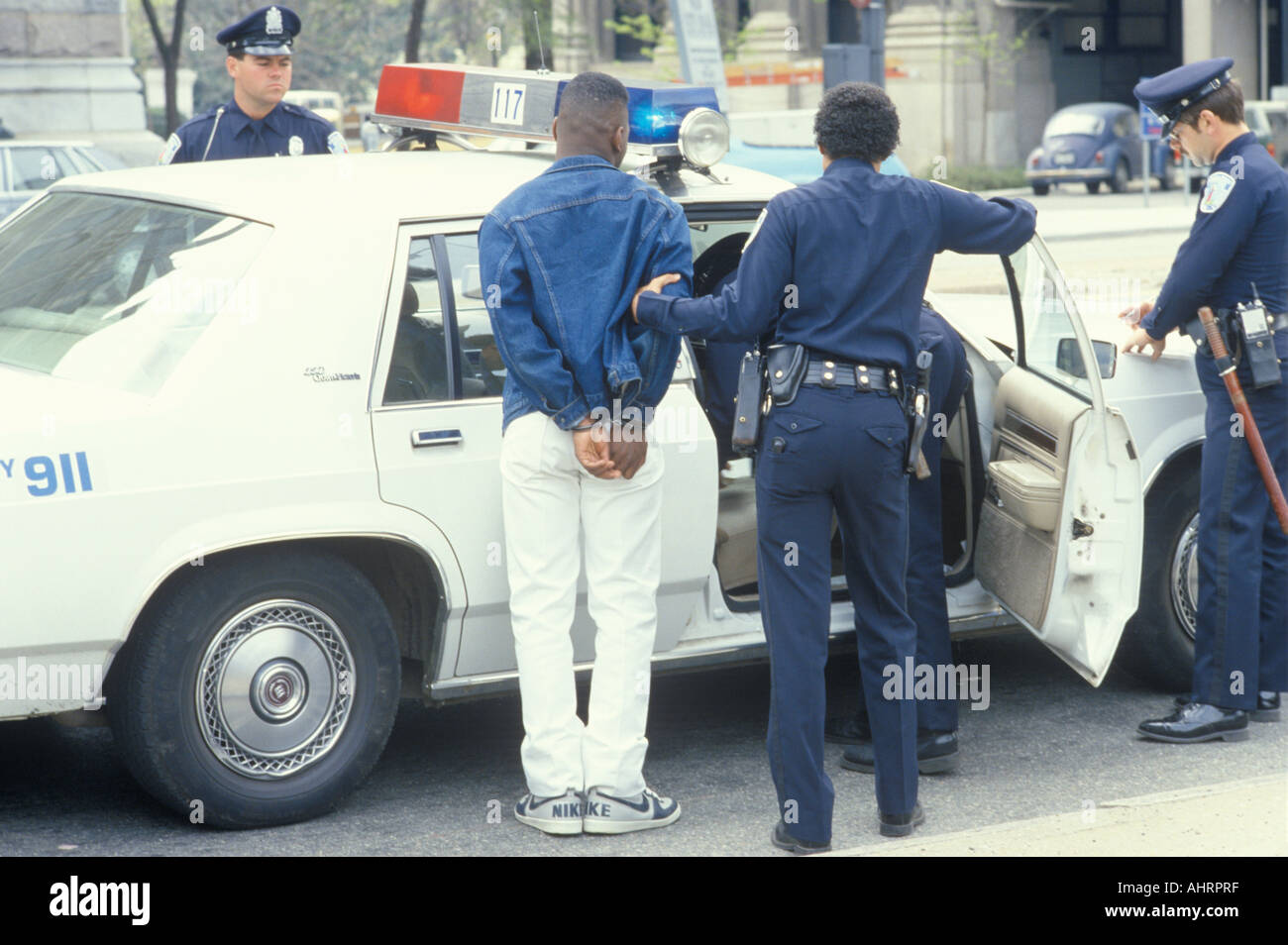 Handcuffed man being put into police car Richmond Virginia Stock Photo ...