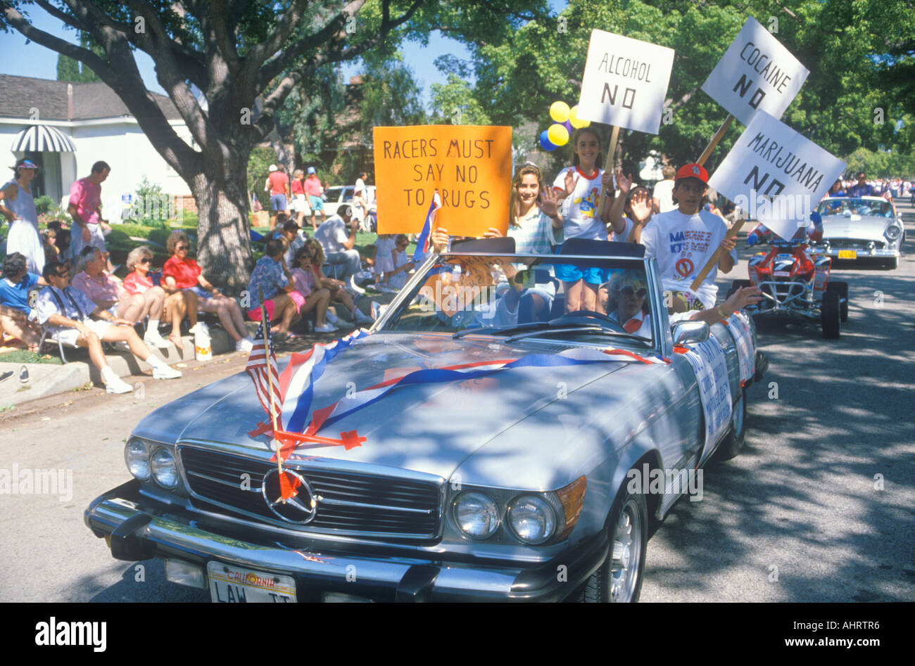 Activists riding in car with signs during anti drug community parade ...