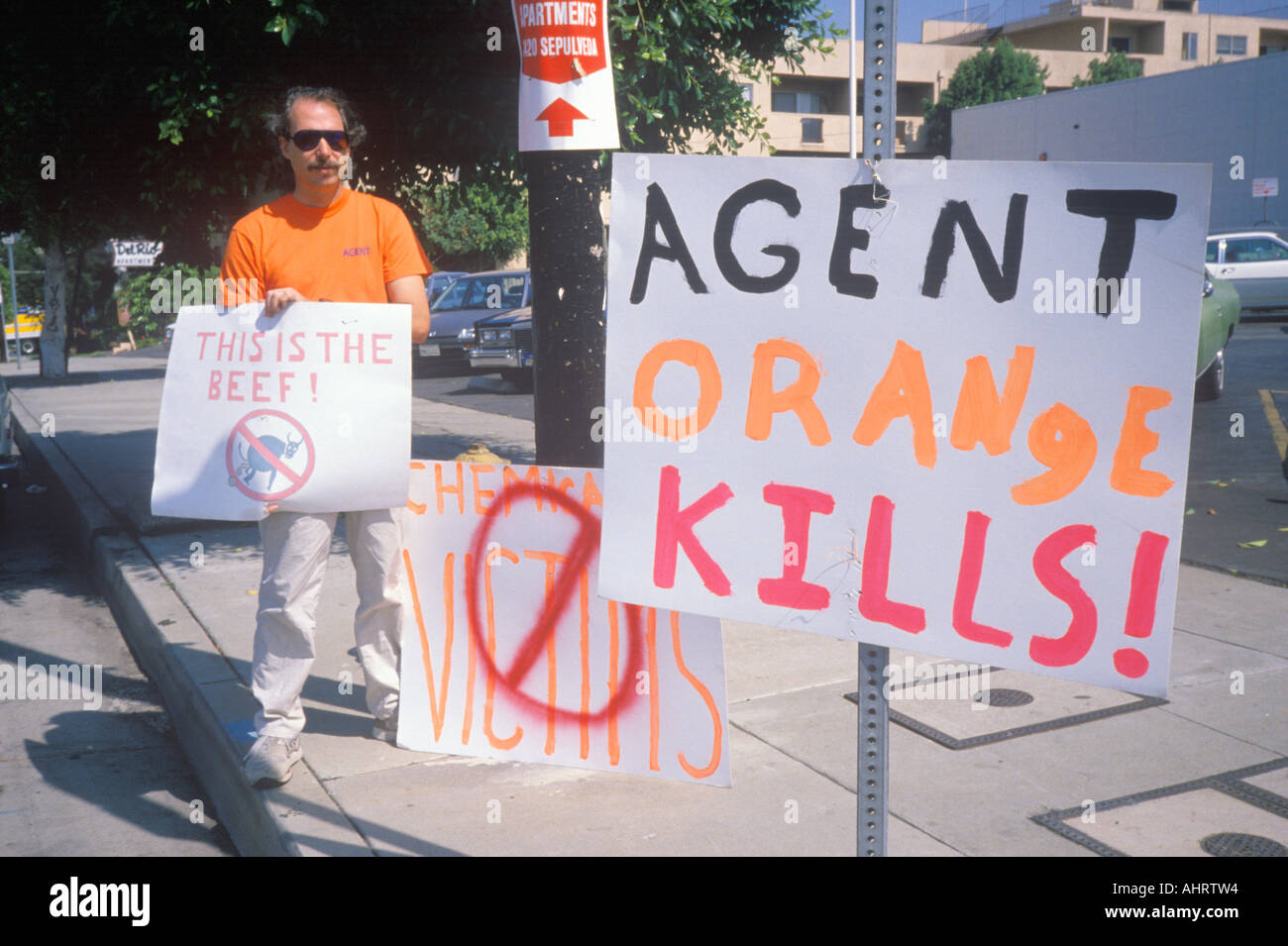 Protester against agent orange chemicals holding signs Stock Photo - Alamy