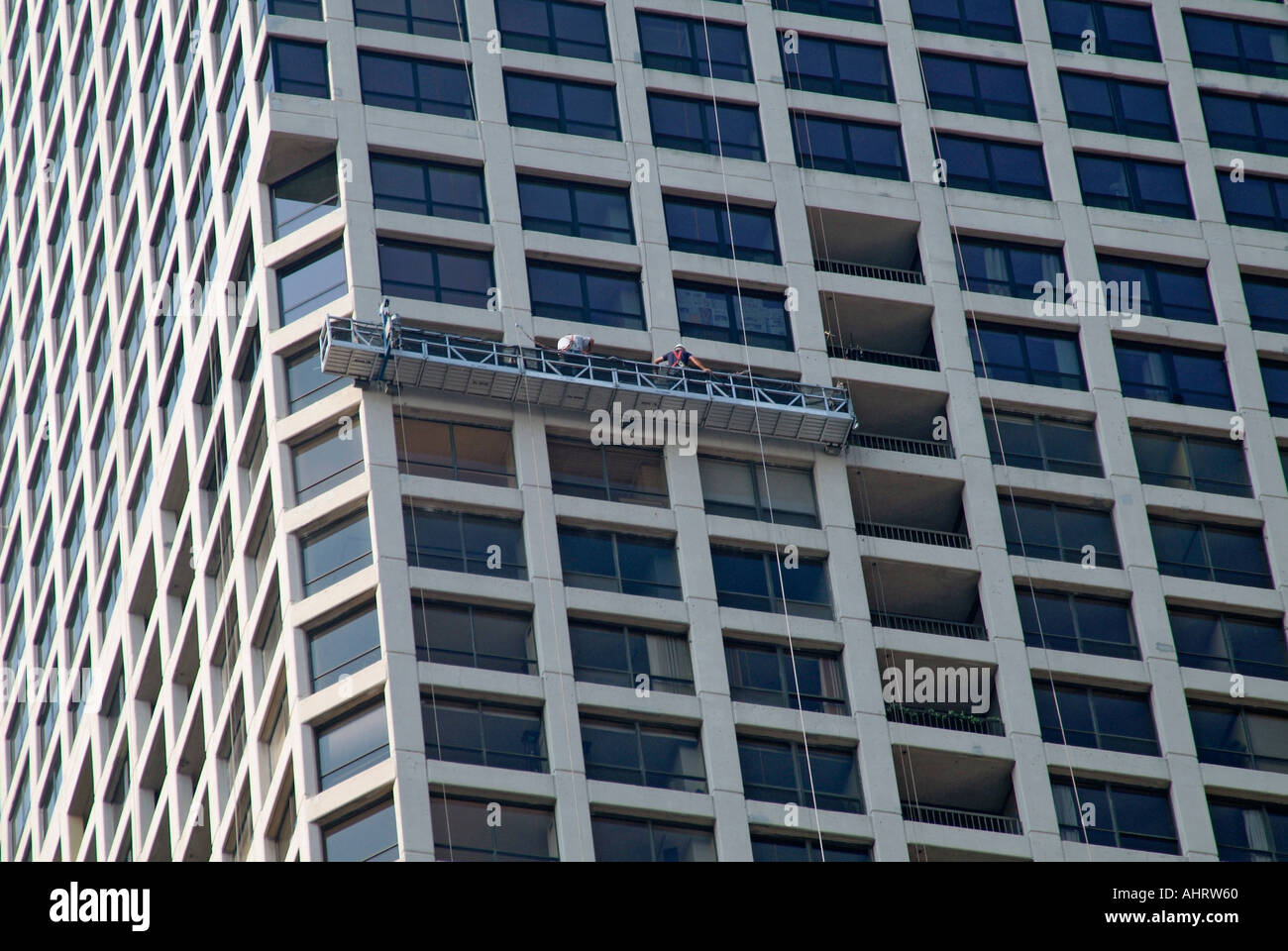 Window washers work at extreme heights to clean windows on tall ...