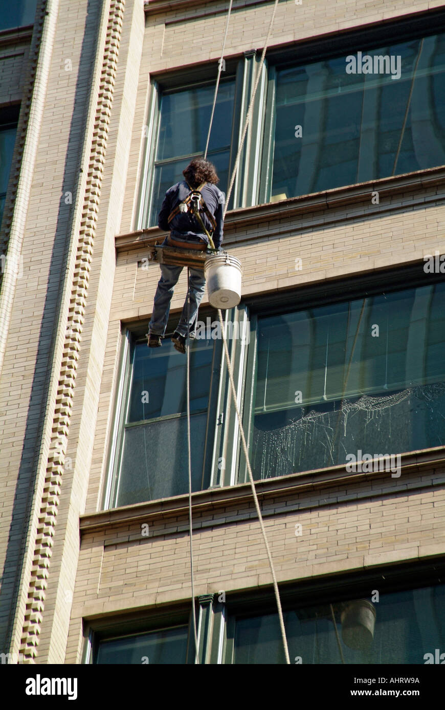 Window washers work at extreme heights to clean windows on tall ...