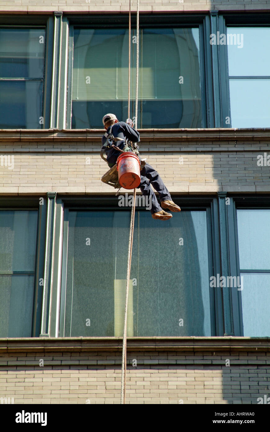 Window washers work at extreme heights to clean windows on tall ...