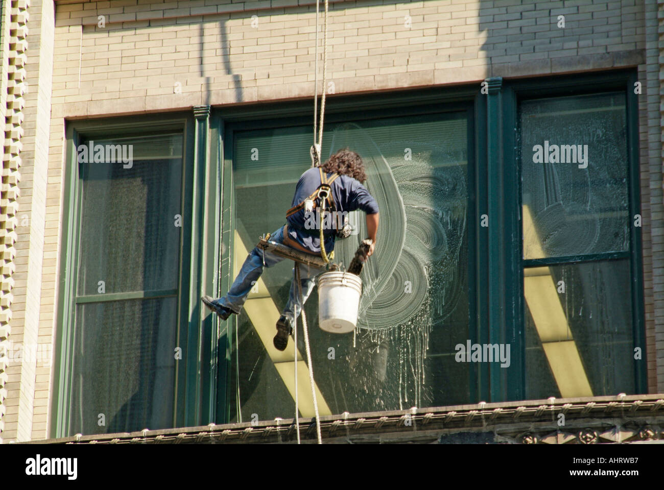 Window washers work at extreme heights to clean windows on tall ...