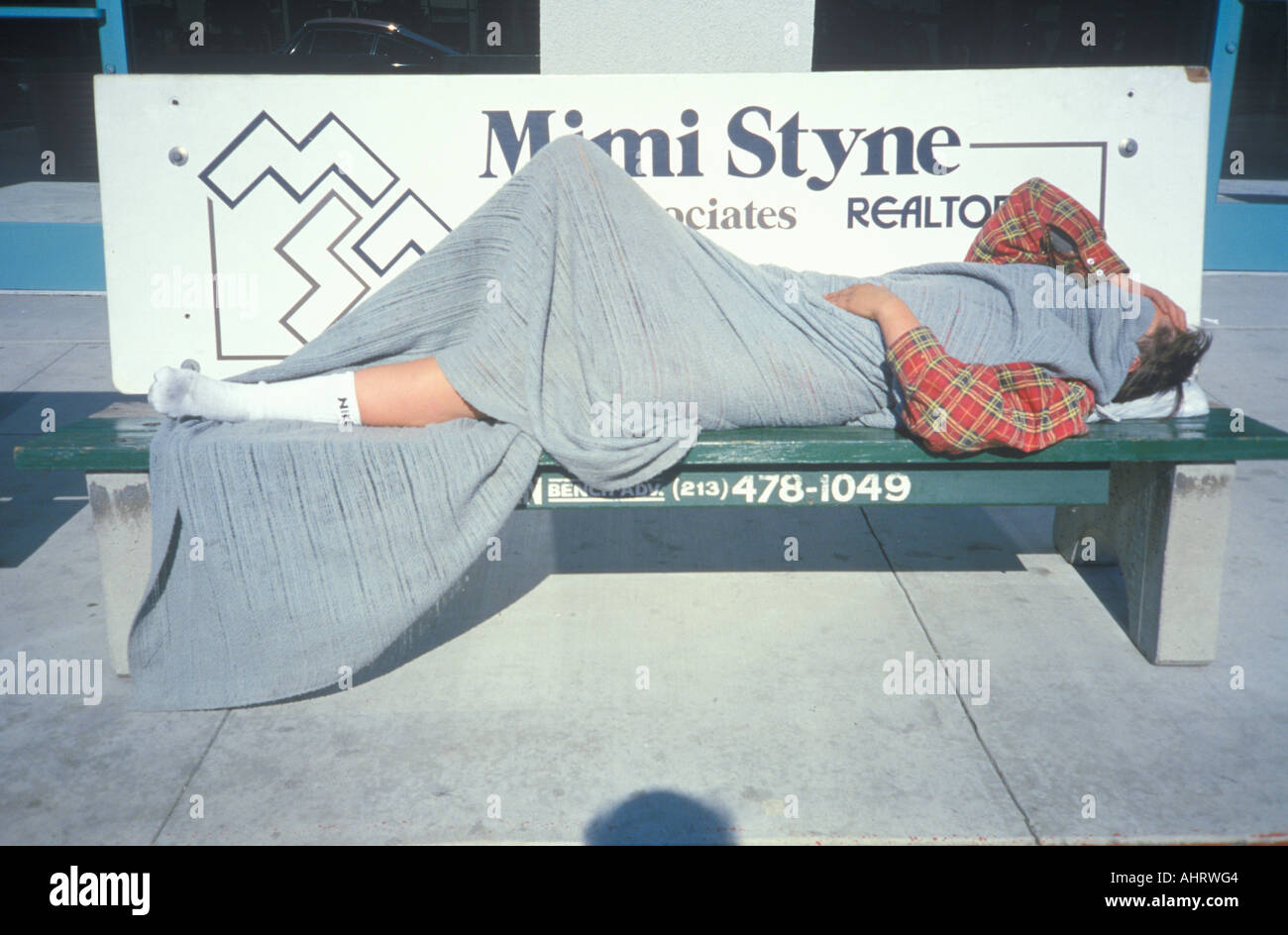 Homeless man sleeping bus stop hi-res stock photography and images - Alamy