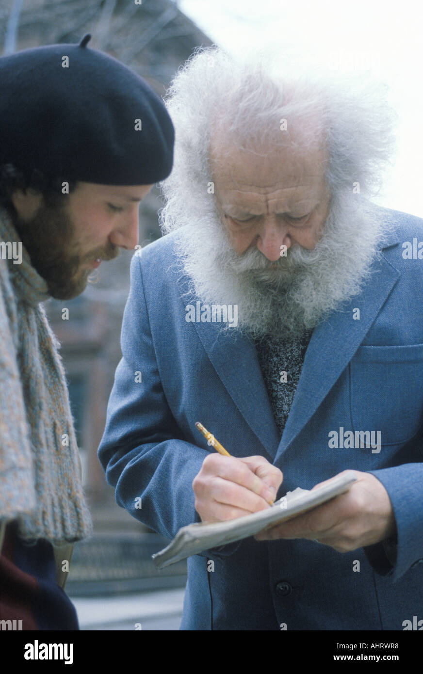 Elderly gentleman writing on a tablet Stock Photo - Alamy