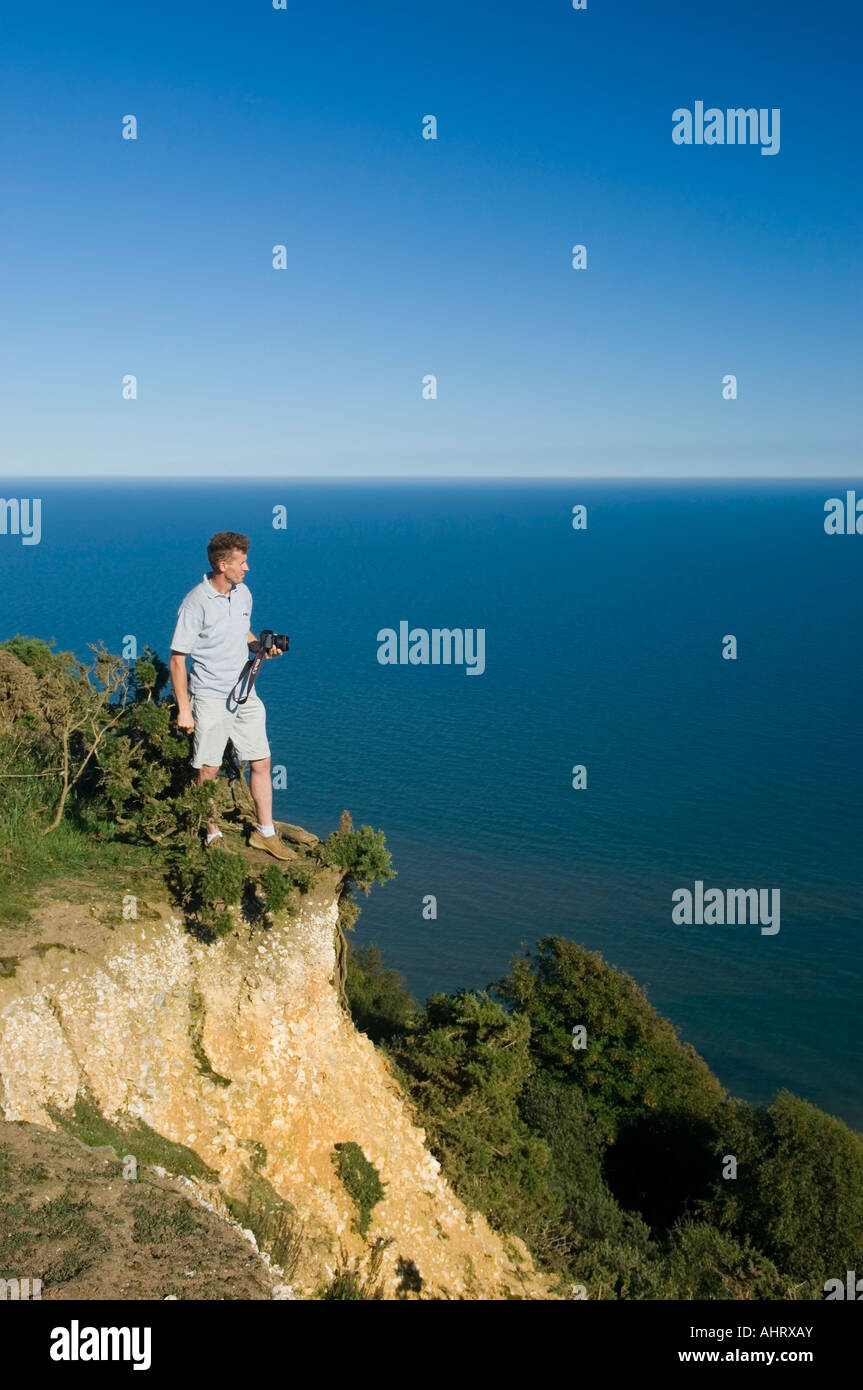 UK England Devon Photographer standing on the Cliff Edge at Peak Hill ...