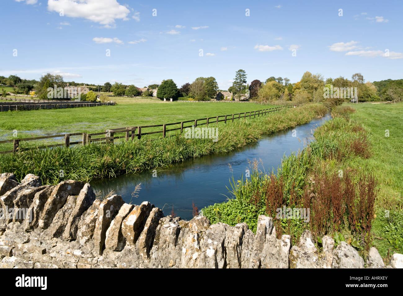 The River Coln at the Cotswold village of Coln Rogers, Gloucestershire ...