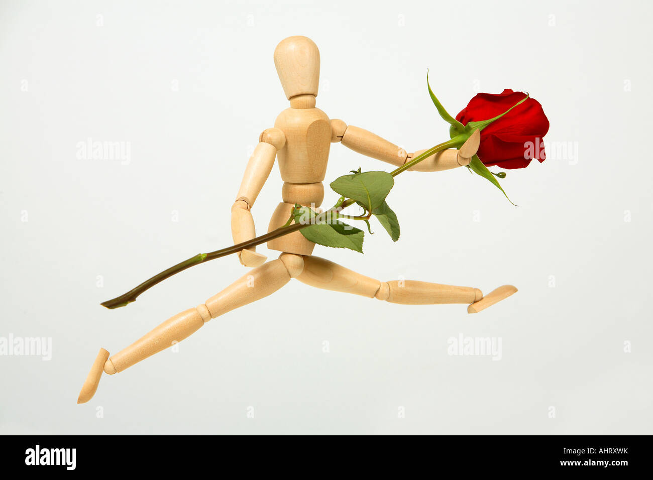 Wooden doll holding a red rose Stock Photo - Alamy