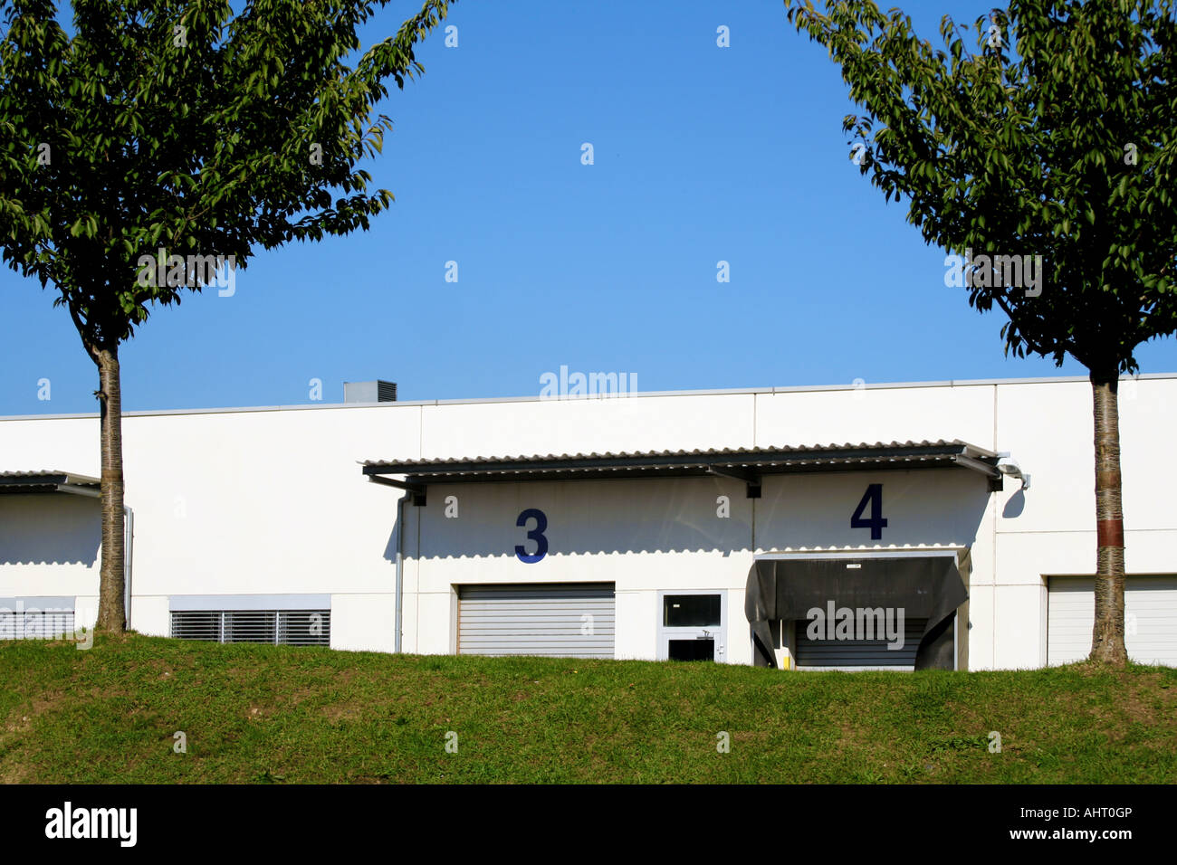 Warehouse and trees Stock Photo - Alamy