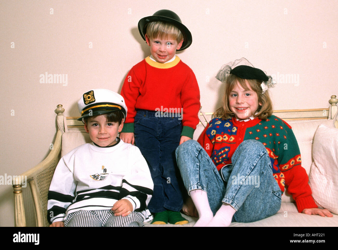 3 kids ages 3 to 7 play dress up Stock Photo - Alamy