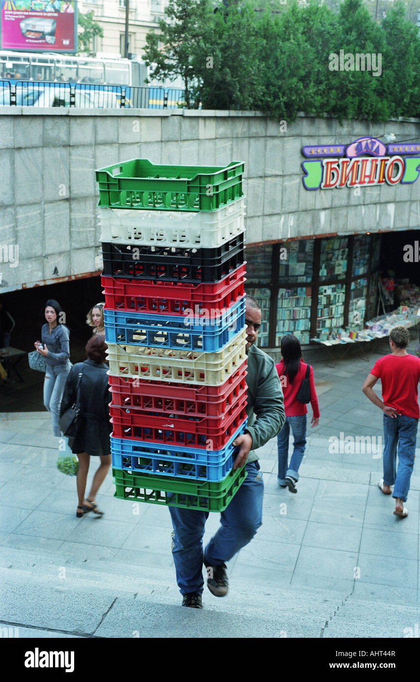 Man carrying empty plastic boxes, Sofia, Bulgaria Stock Photo - Alamy