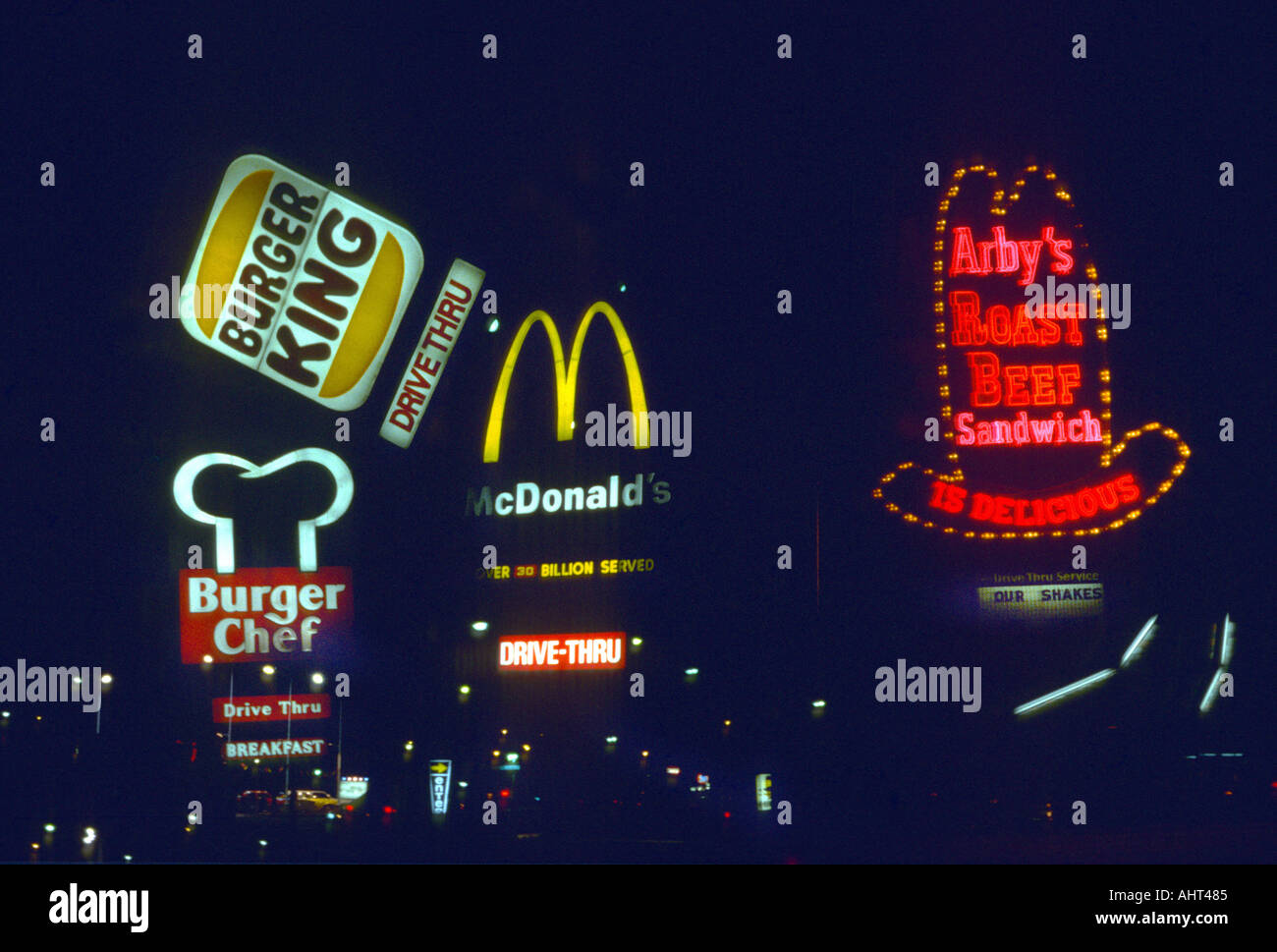 Montage of fast food eating signs at night Stock Photo - Alamy