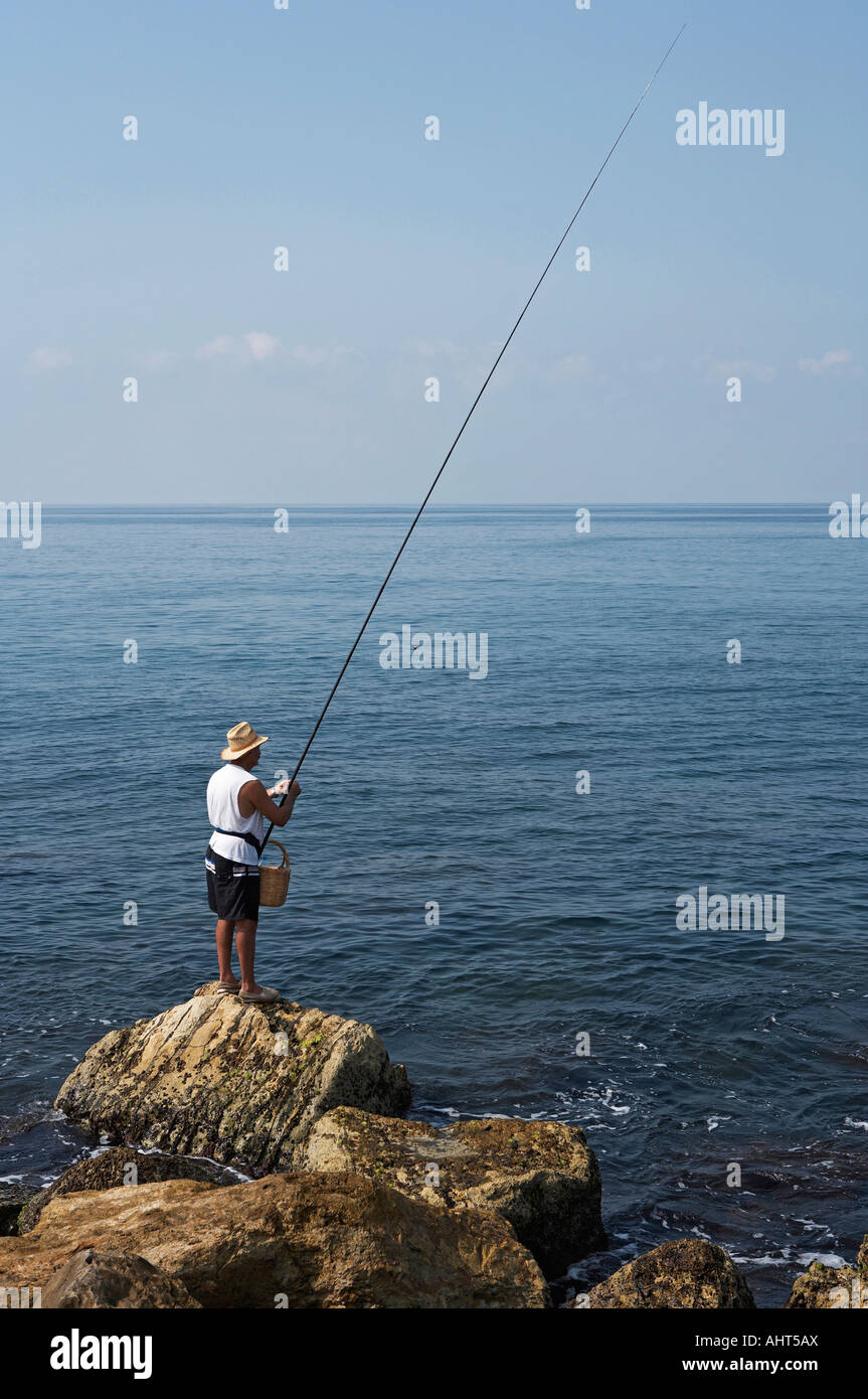 Lebanon Byblos arab fishing from the rocks Stock Photo - Alamy
