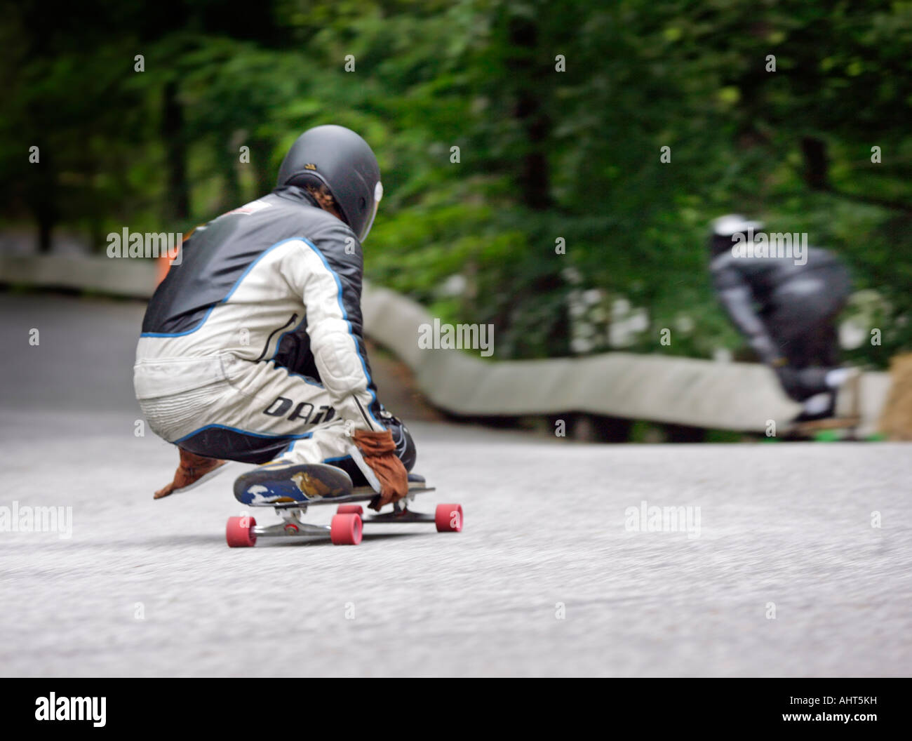 Young man speeding Downhill Longboard Skateboard competition on ...