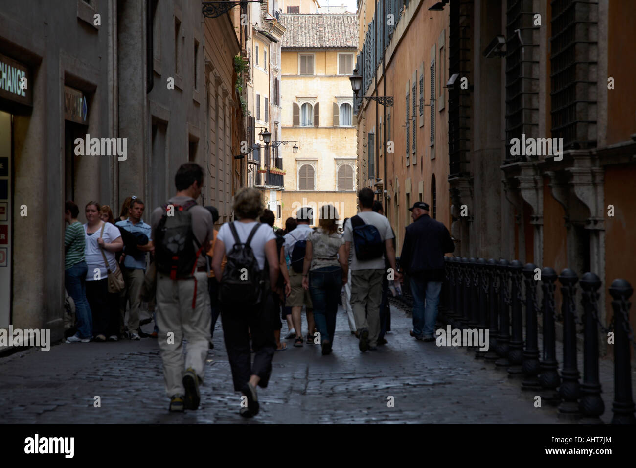 tourists walk down narrow back streets in the old city Rome Lazio Italy ...