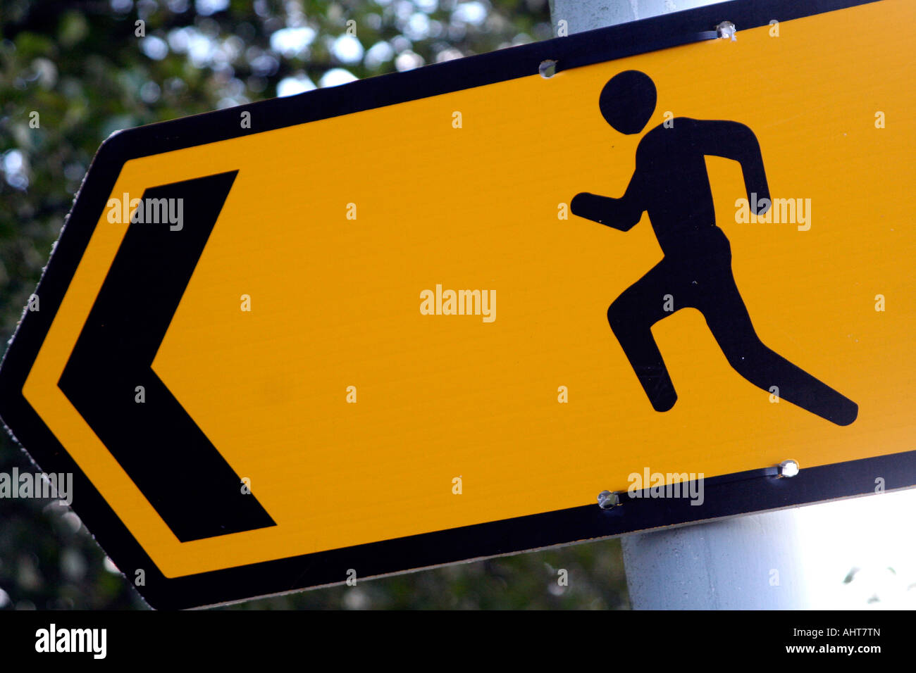 sign pointing towards running track Stock Photo - Alamy