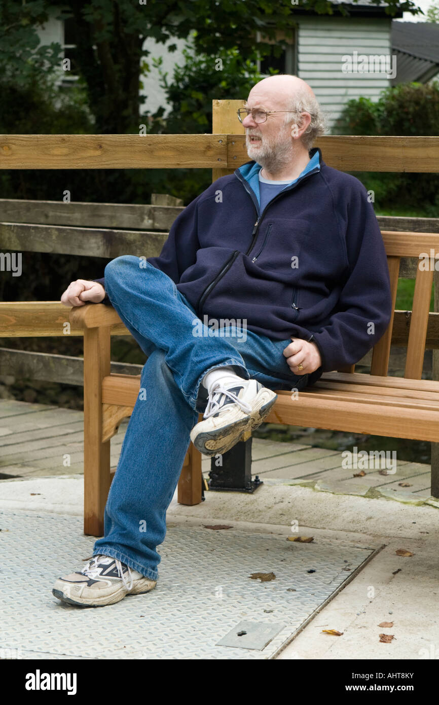Man sitting on a bench Stock Photo - Alamy