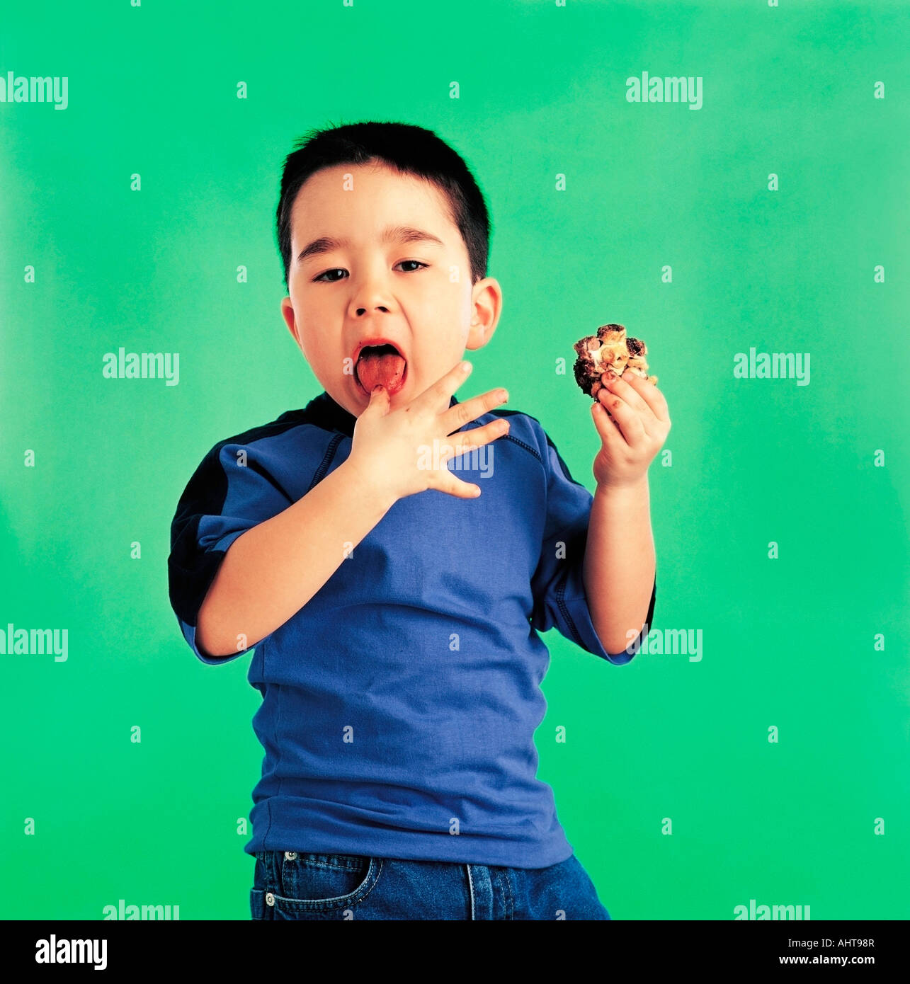 A boy child children eating a cookie cookies hi-res stock photography ...